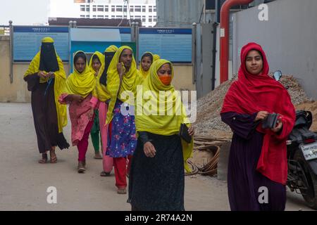 Female workers of a ready-made garment enter in a factory at Fatullah ...