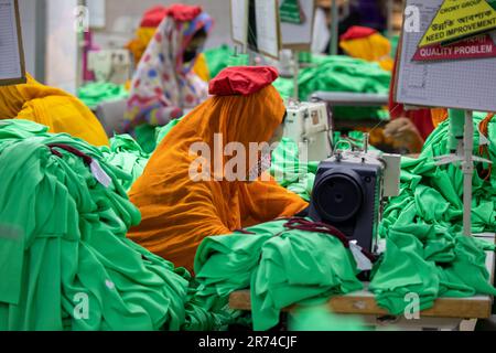 A ready-made garments (RMG) worker working in a factory at Fatullah in ...