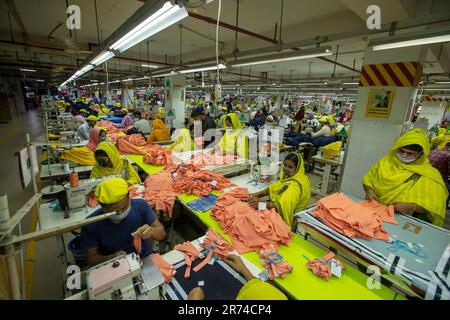Ready-made garments (RMG) workers working in a factory at Fatullah in ...