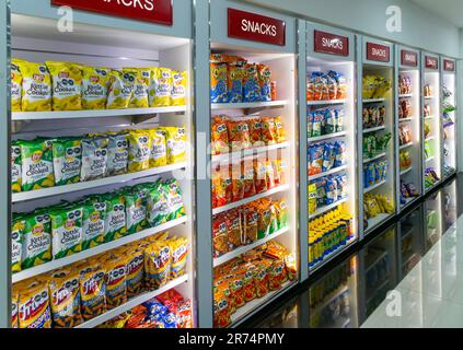 Display rows in shop of packets of Cheetos crips, bags of chips, potato ...
