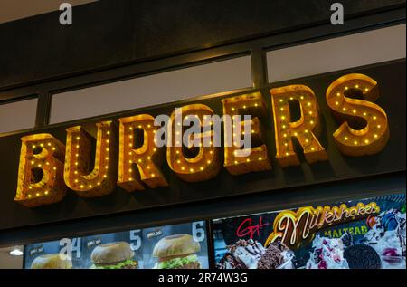 Burgers sign at Flavortown cafe restaurant bar, departure lounge area ...