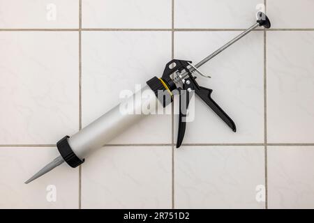 Cartridge press lies on floor tile, cartridge nozzle, blur Stock Photo ...