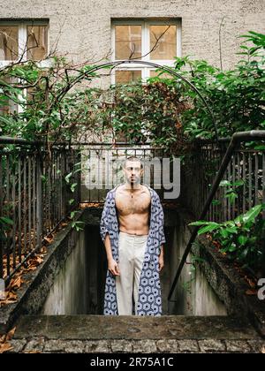 man, short hair, coat, basement stairs, standing, view camera Stock ...
