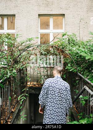 man, short hair, coat, basement stairs, standing, gaze lowered Stock ...