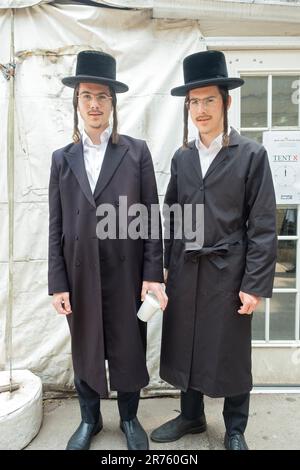 Orthodox Jewish brothers with long peyot pose for a photo outside a ...