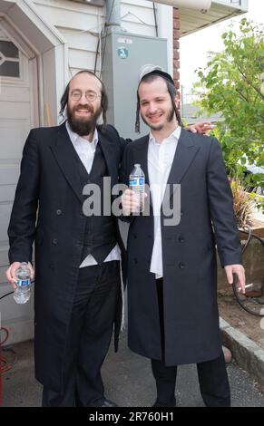 Orthodox Jewish brothers with long peyot pose for a photo outside a ...
