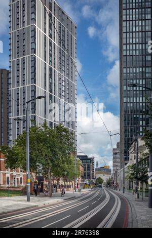 A view along the tramlines and between the high rise buildings of ...