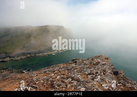 Mist gathering over a cove at Rhosilli Bay Gower Peninsula Wales Stock ...