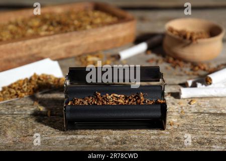 old cigarettes rolling machine Stock Photo - Alamy