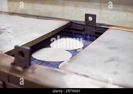 Automatic roti making machine at Gurudwara Bangla Sahib temple ...