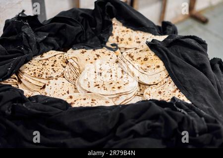 Batch of chapati round flatbreads in bucket for langar in sikh ...