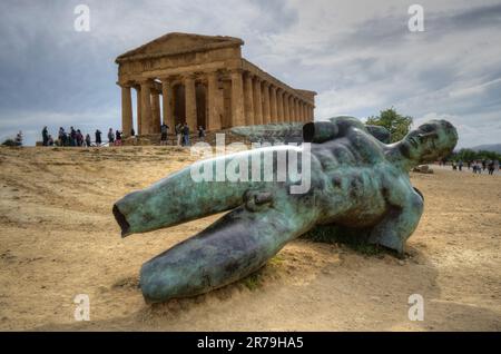 Statue of fallen Icarus in bronze in front of the 2,400 year old Temple ...