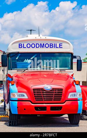 A mobile blood donation center, commonly known as a bloodmobile, is parked outside a store, June ...