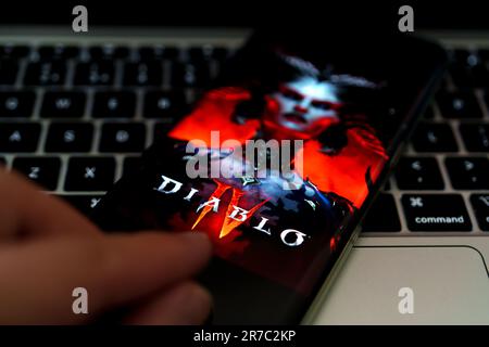 Diablo 4 game poster seen on mobile screen. Diablo IV is a game ...