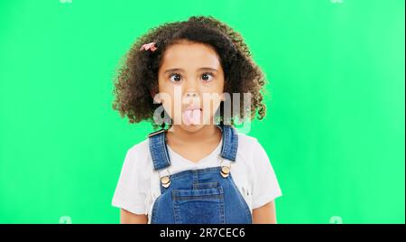 Fun kids face. Portrait of silly teenager child girl smiling and showing tongue in camera making ...