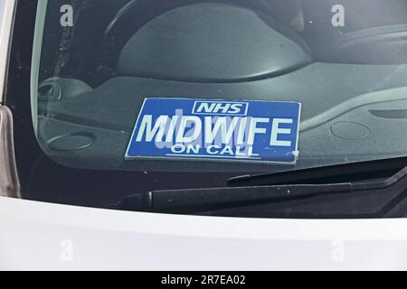 NHS Midwife On Call sign on dashboard of parked car Stock Photo - Alamy