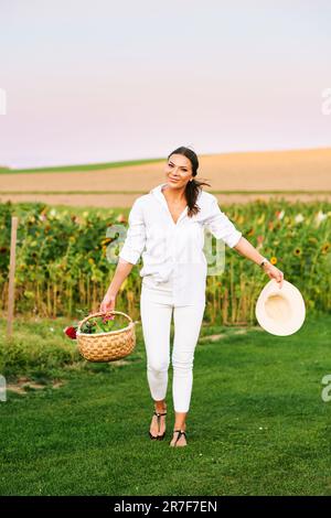 Woman with beautiful chrysanthemum flowers on orange background Stock ...
