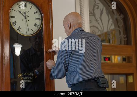 Andre Viger winds up the mechanism of a King Edward model clock built ...