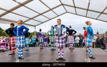 Girls competing in highland dancing event wearing traditional Scottish ...