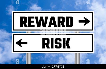 Risk & reward road sign on blur background Stock Photo - Alamy