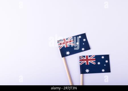 Overhead view of small australian flags over white background, copy ...