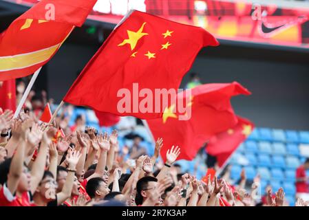Chinese football fans wave national flags and shout slogans to show ...