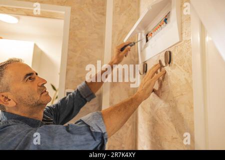 Technician installing fuse box at sustainble home Stock Photo - Alamy