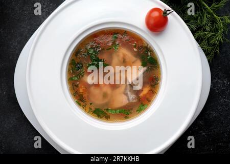Red fish ear with tomatoes, garlic and spices Stock Photo - Alamy