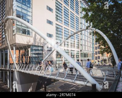 Commuters and city workers on the butterfly bridge at Manchester ...