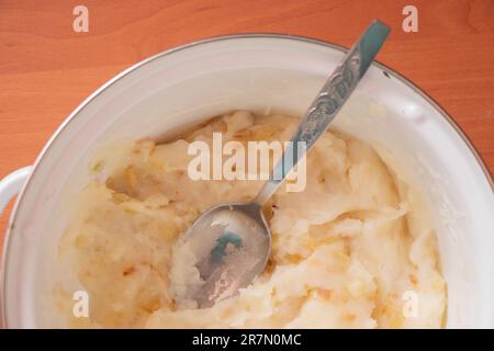 Mashed potatoes in a pan on wooden rustic table. Wooden background. Top ...