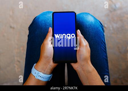 In this photo illustration, the Wingo logo is displayed on a smartphone ...