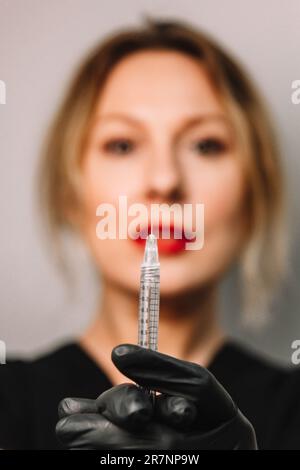 Plastic surgeon doctor injects Botox into the egg concept of injections ...