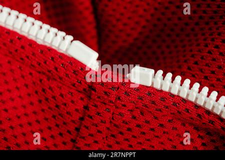 red sportswear closeup top view. white zip line. breathable knitwear ...