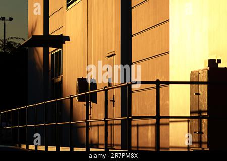 Random street photography of a side of a building with a railing at ...