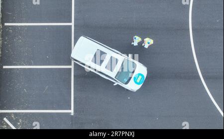 Vehicles take part in an automatic parking test at the Deqing ...
