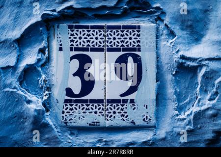 Vibrant blue house post: Numbers adorn this eye-catching house post ...