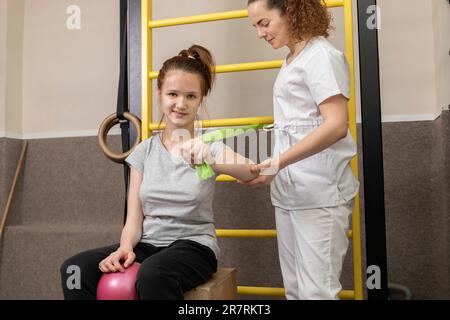 Disabled Child With Physician Does Physical Exercises In Gym. Kid With ...