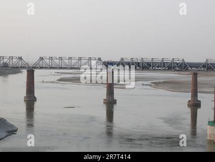 An Indian passenger train passes over a bridge on river Ganges in ...