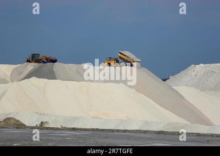 Dump truck unloading salt at a salt mine for salt extraction, salt ...
