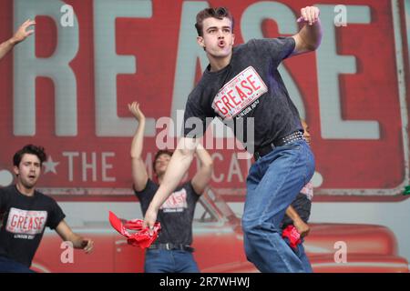 The cast of the musical Grease perform live on stage at West End Live ...