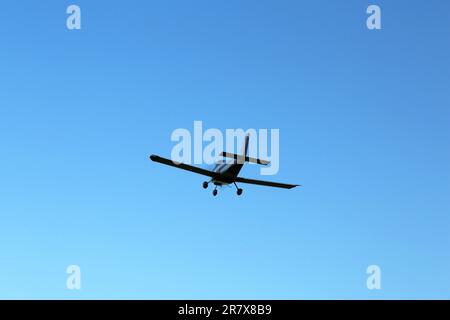 Modern ultralight airplane flying in blue sky Stock Photo - Alamy