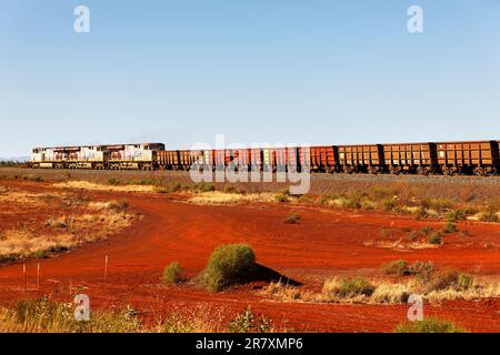 Empty iron ore railway carriages returning to mine site, Pilbara ...
