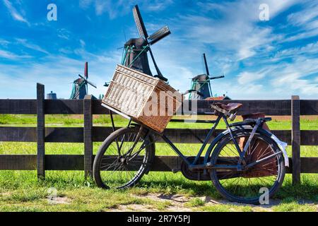 Bicycle with windmill and blue sky background. Scenic countryside ...