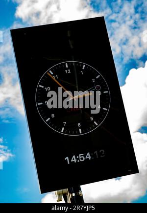 Modern digital train station clock & passengers disembarking TFL metro ...