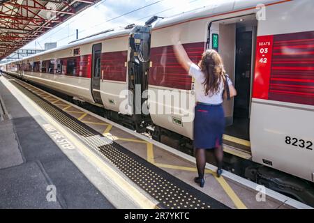 train guard signaling for train to depart Stock Photo - Alamy