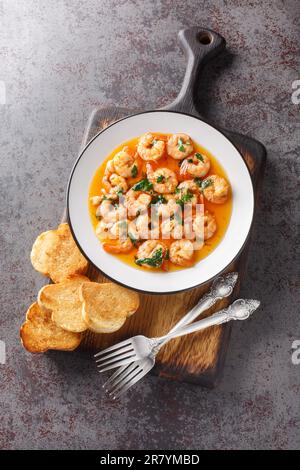 Plate of toasts with garlic and parsley on light background, closeup ...