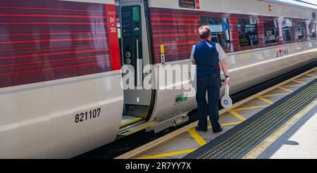 Grantham Train Station – A female conductor or guard despatching a ...