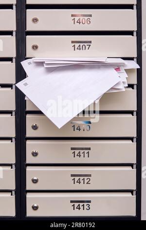 Mailboxes filled with letters and bills in an apartment building. An ...