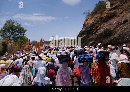 A group of people singing and dancing during a parade on the streets of ...