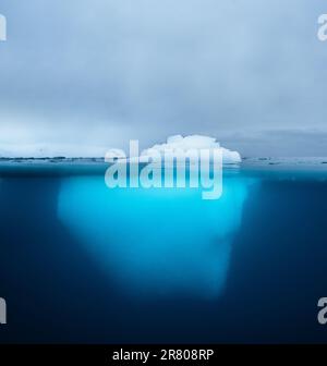 Split view of an iceberg showing above and below the water line ...